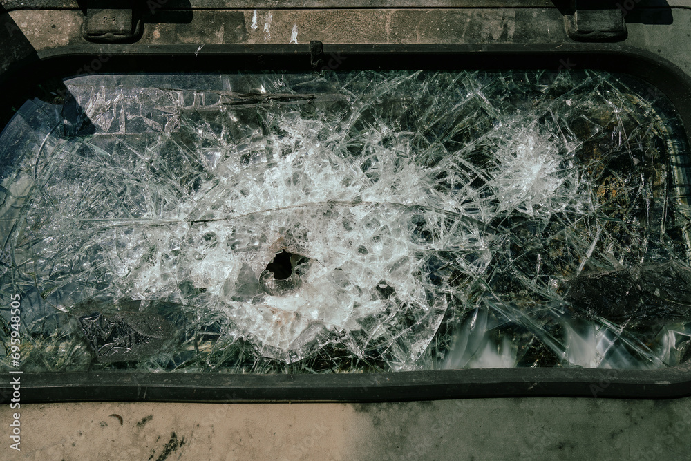 Bullet hole in armor-piercing glass. Armor piercing glass of damaged ...