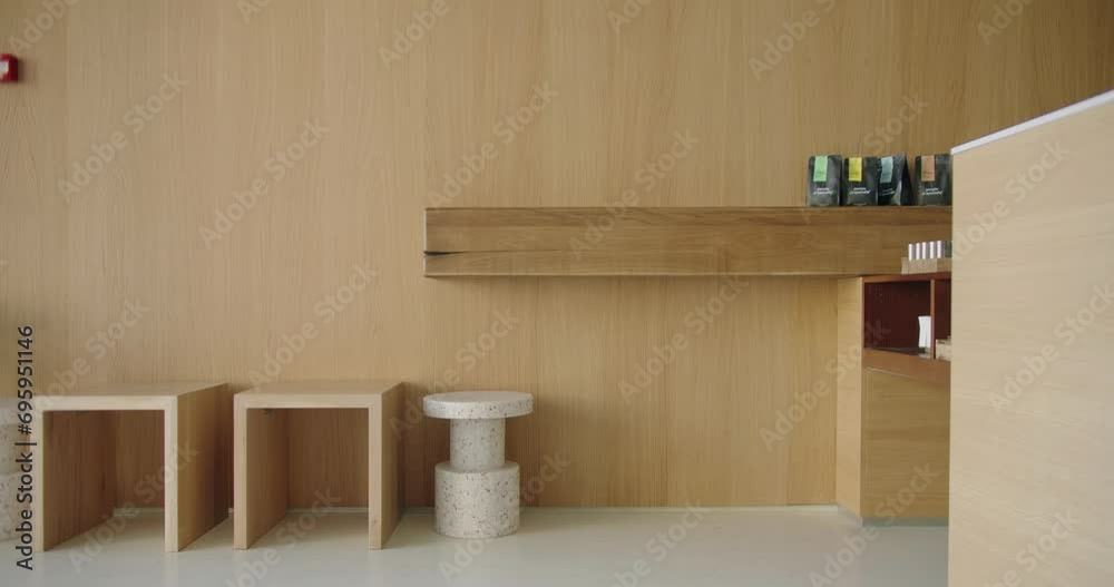 Detail in coffee house interior, wooden stools, shelf and cafe counter ...