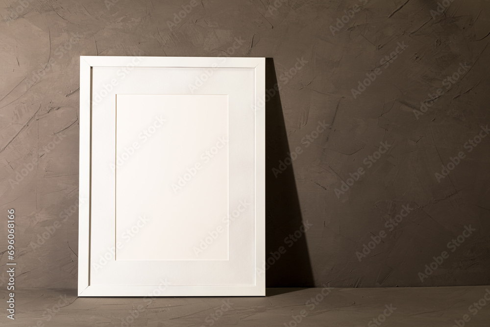 White frame leaning on dark plaster wall Stock Photo | Adobe Stock