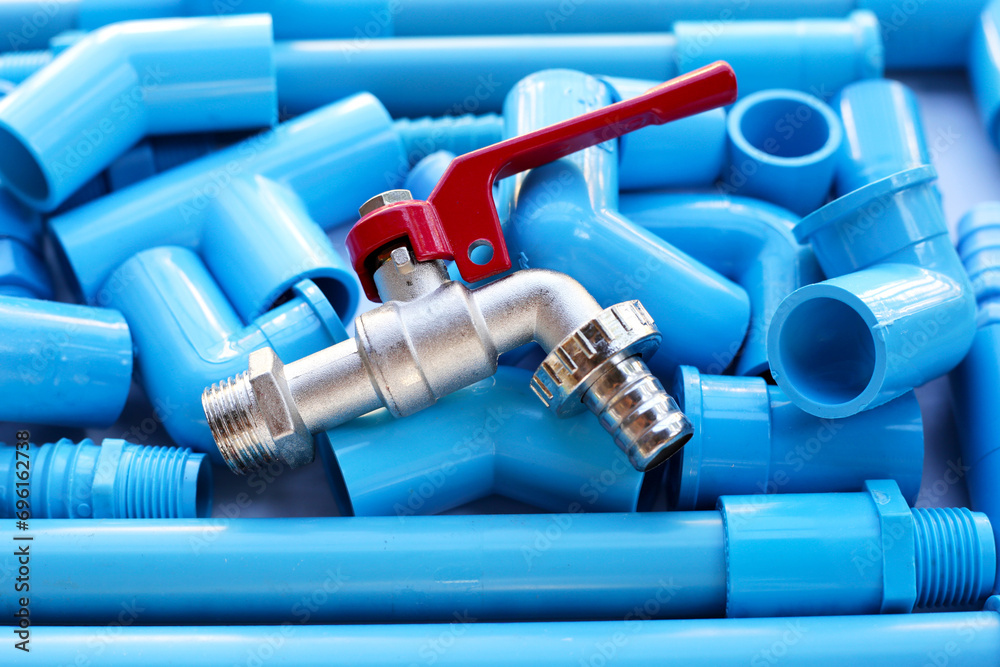 Faucet with blue pvc pipe connections for plumbing work. Plumber ...
