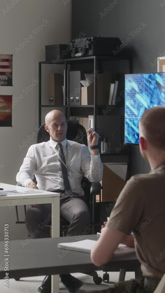 Vertical side shot of unrecognizable army officer listening to military ...