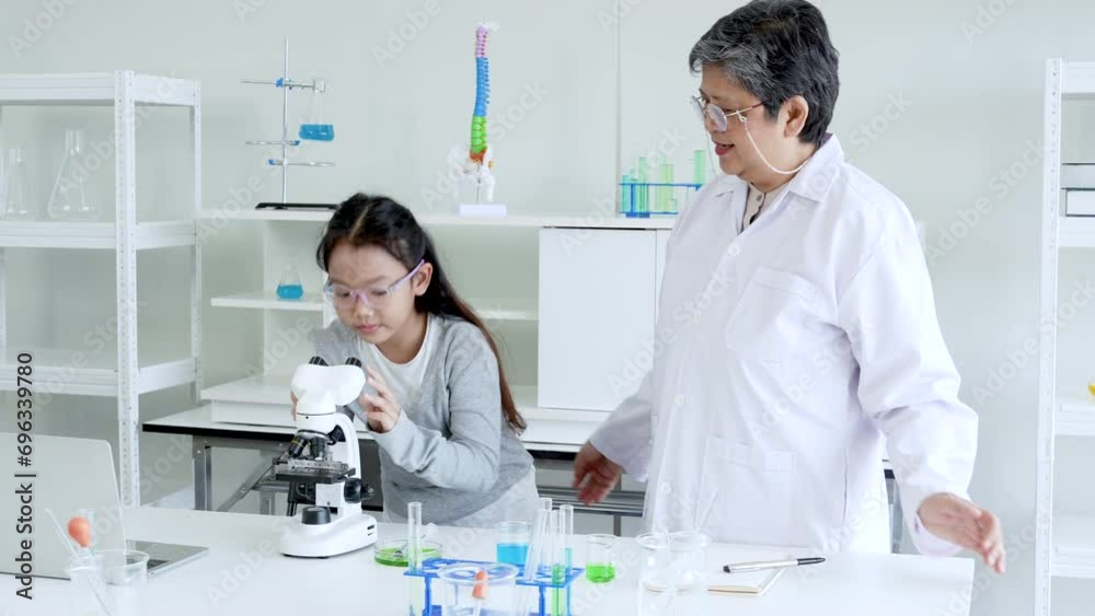 An Asian girl student kid enjoy study, learn, participate on test tube ...