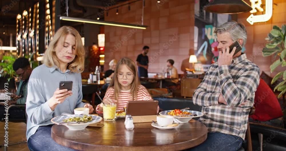 Camera view of Caucasian family using technology devices during their ...