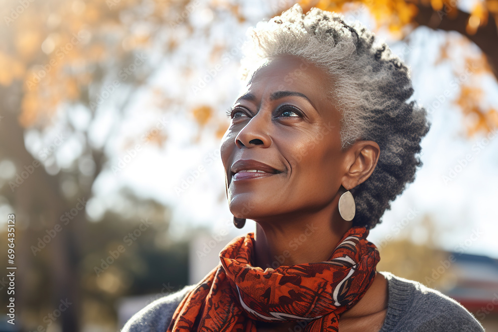 Close-up outdoor portrait of a thoughtful senior black woman, an emblem ...