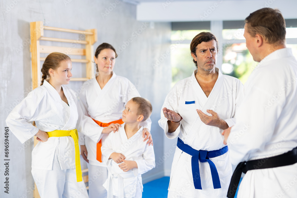Parents with children after finishing karate classes communicate with ...