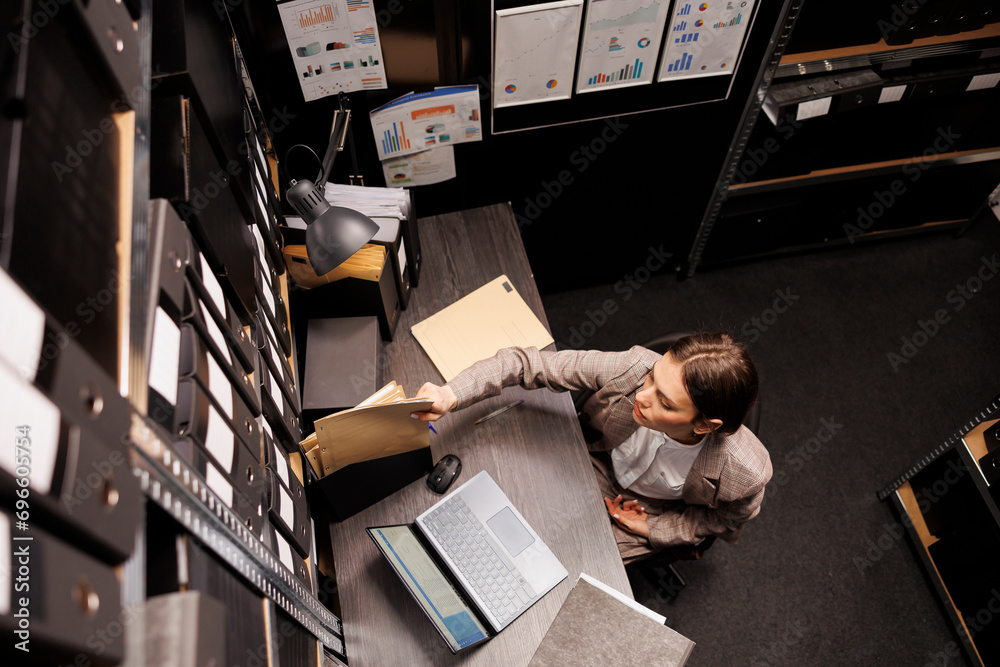 Top view of police officer typing criminal case report on laptop ...