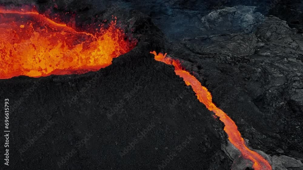 Erupting volcano, red hot magma boiling and splashing out a crater ...