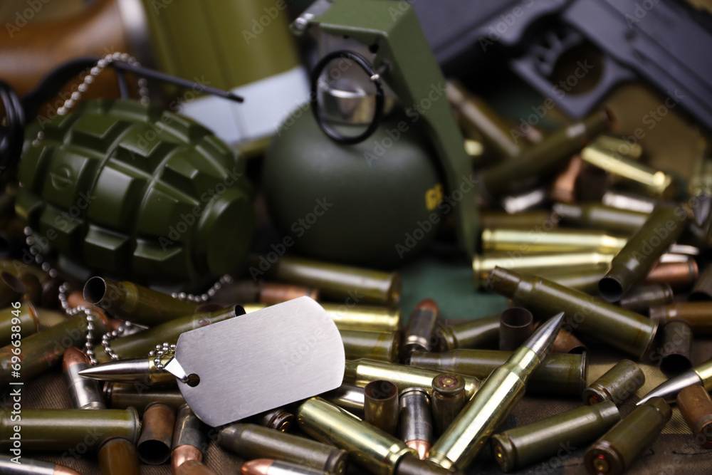 Different types of ammunition and grenades on a camouflage background ...