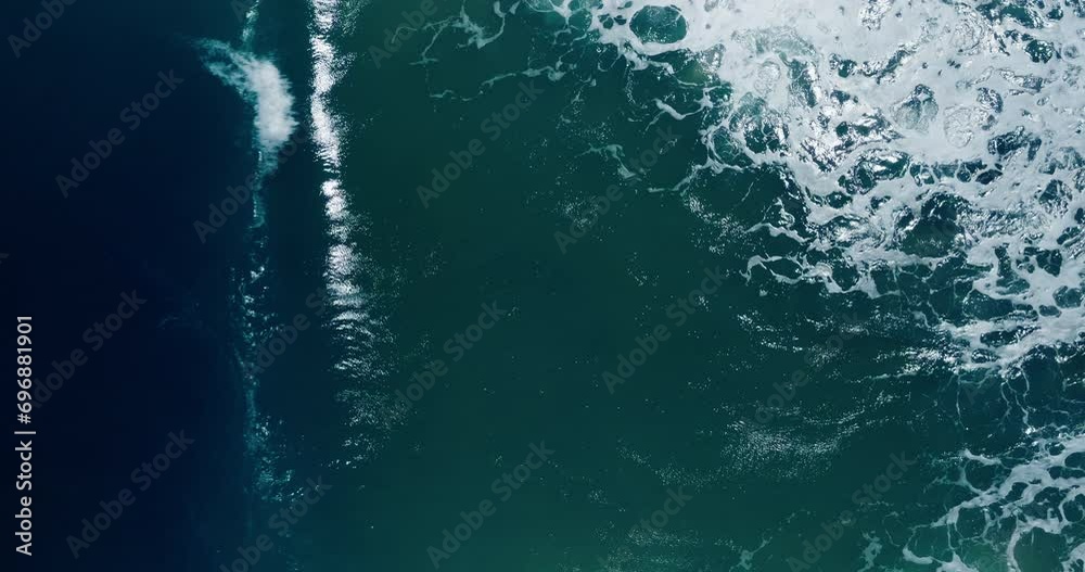 Amazing Top-down aerial view of the powerful deep blue ocean waves during the monsoon season ...