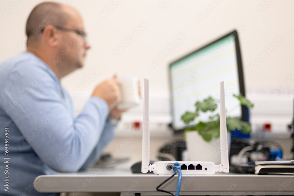 Wi-Fi router installed on a desktop in the office. In the background ...