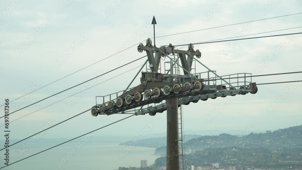 Support of ski lift with rotating rollers. Cable car passes by the ...