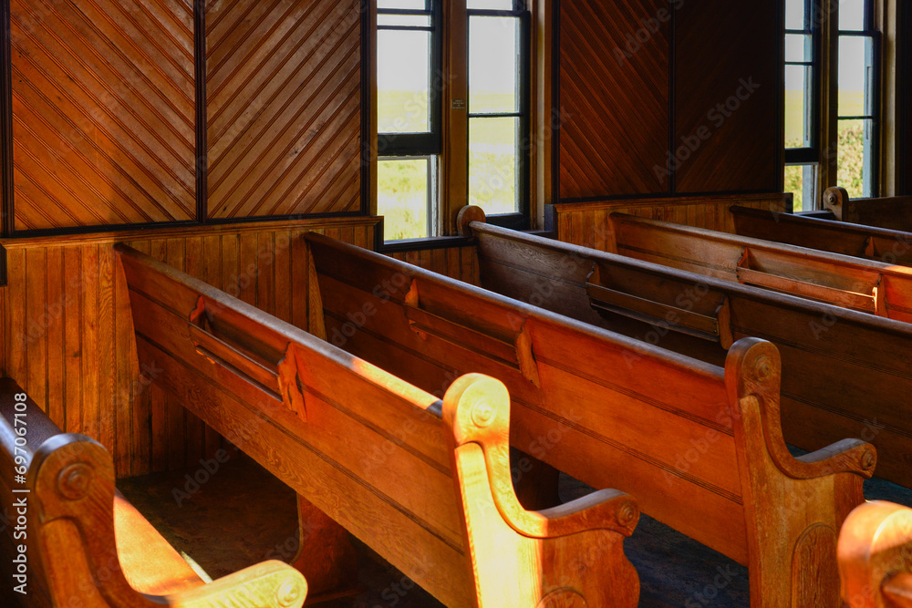 The interior of a vintage church with wooden pews or benches made of ...