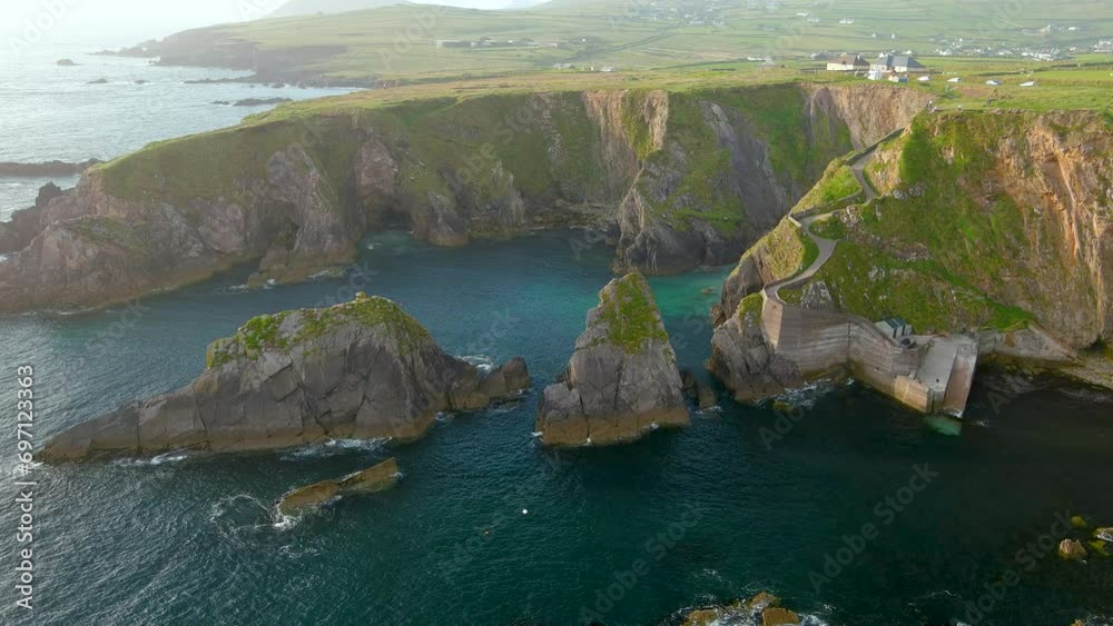 Dunquin or Dun Chaoin pier, Ireland's Sheep Highway. Aerial view of narrow pathway winding down ...