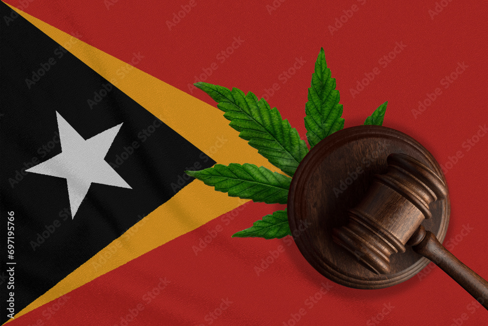 Flag of East Timor and justice gavel with cannabis leaf. Illegal growth ...