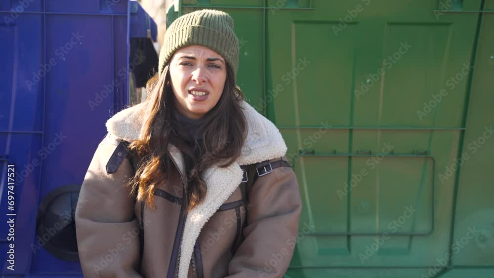Young homeless woman with mental health issue sitting on the street ...