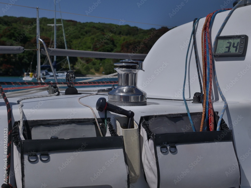 Sailboat winch with sheet bags and winch handle on side of cockpit ...