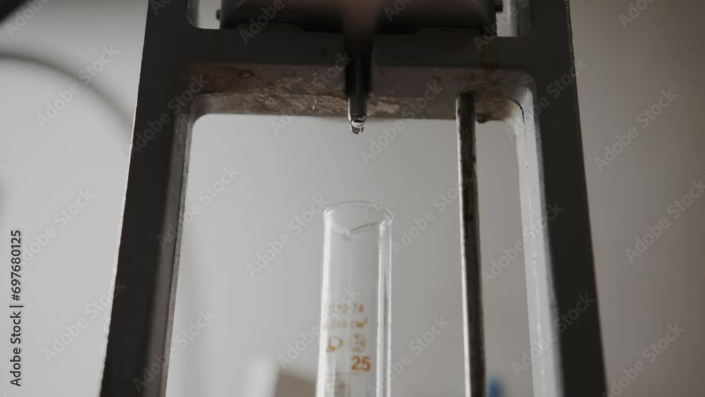 Liquid drips down into test tube at crude oil fractional distillation ...