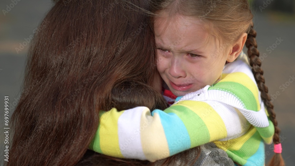 little child cries, tears child face, mother calms capricious kid girl ...