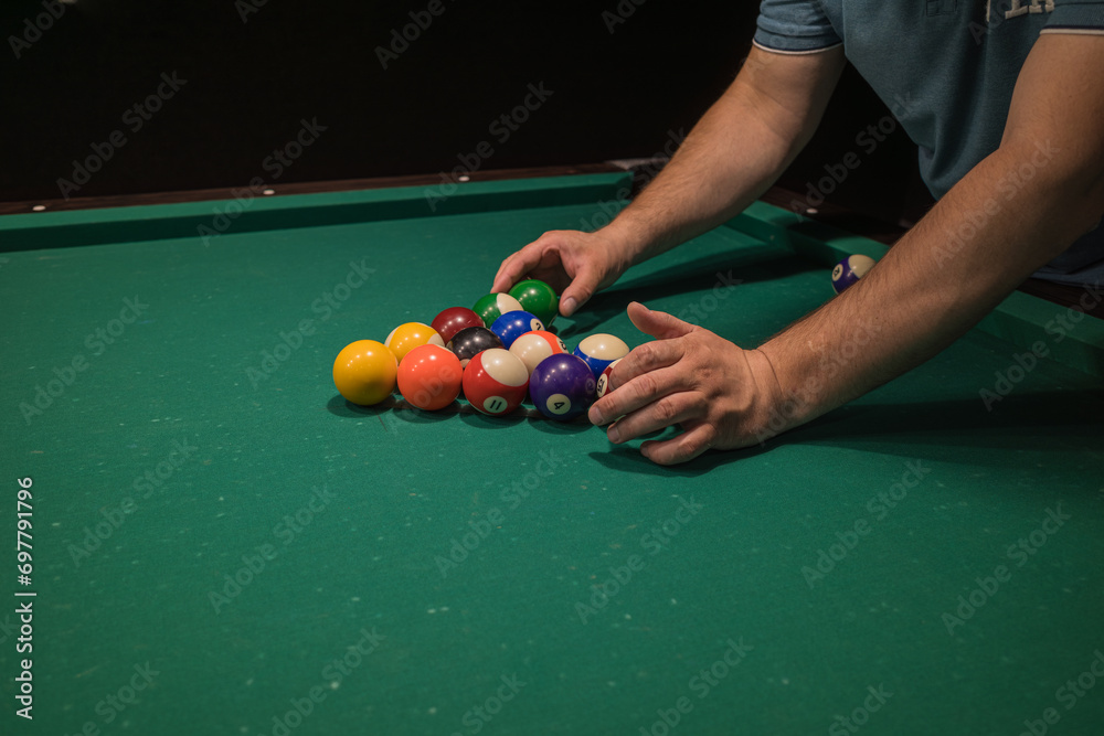 the player places the balls on the billiard table. a game of billiards ...