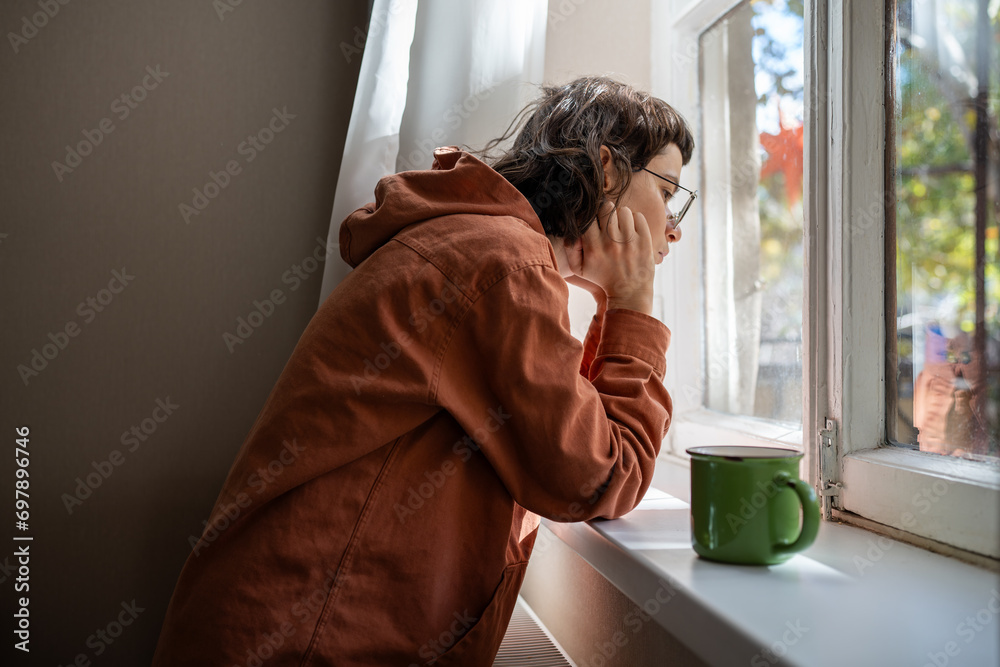 Introverted teenager spending time alone at home in warm sunny day ...