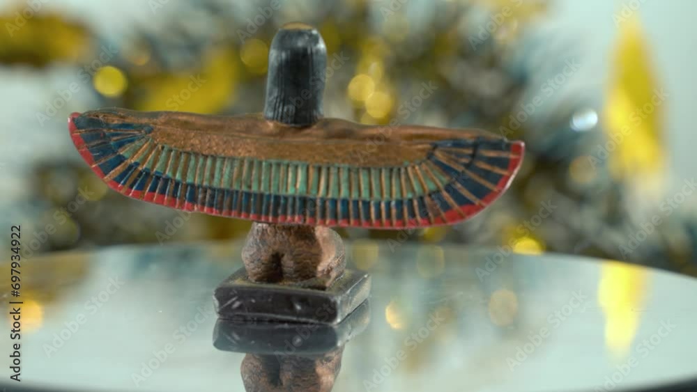 Dreamy close-up shot of a Cleopatra statue with wide open wings, hazy ...