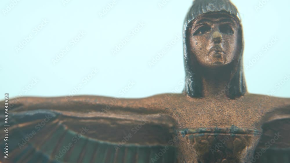 Dreamy macro shot of a Cleopatra statue with wide open wings, hazy ...