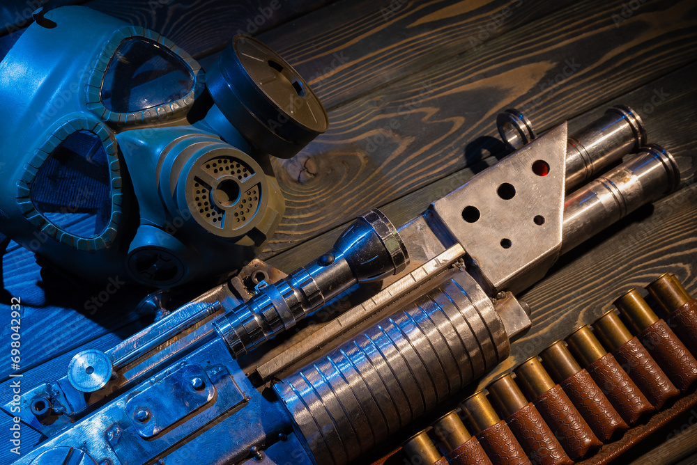 Sci fi post apocalypse pump shotgun and gas mask on the survivor table ...