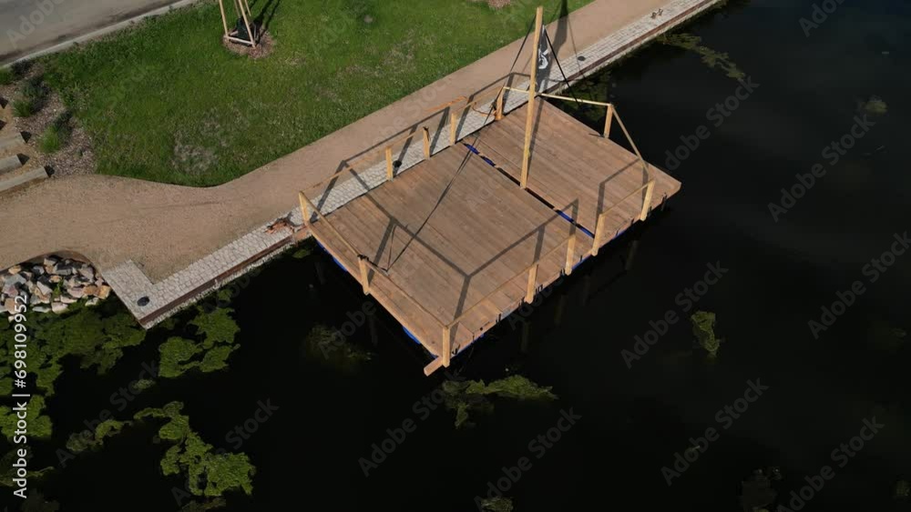 Pier for park visitors. two steps lead to it. planks terrace over water ...