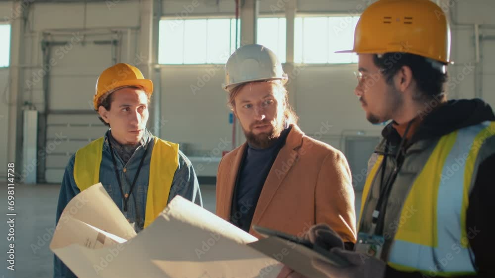 Medium side shot of Caucasian bearded businessman discussing building ...