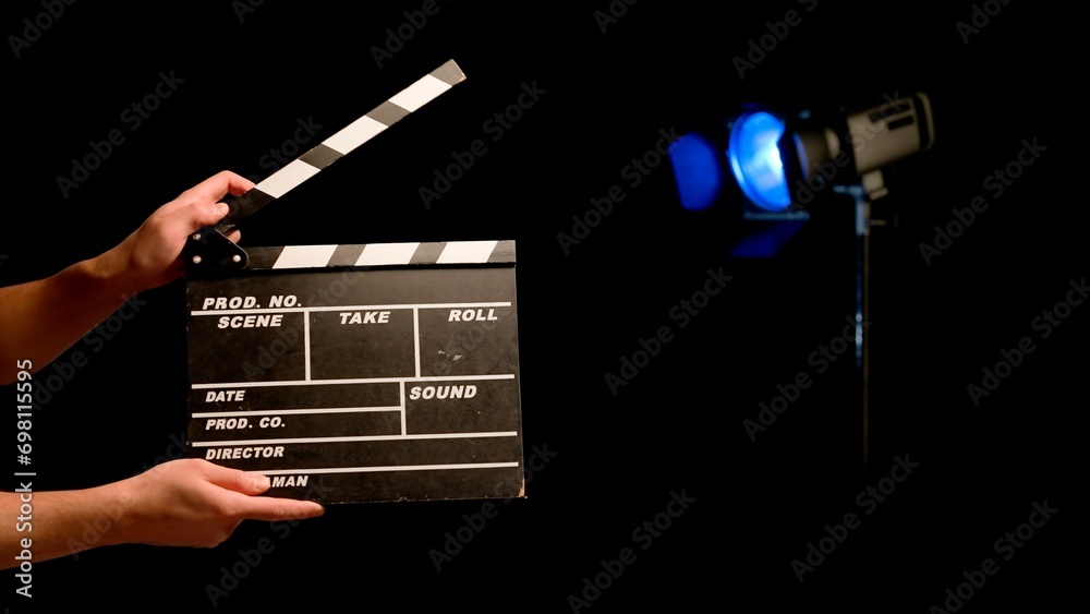 Director's assistant holding movie clapper on filming location. A film ...