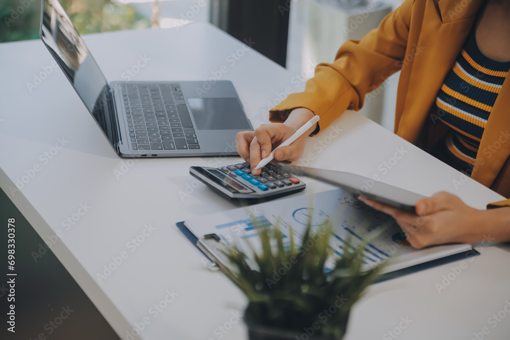 Charming Young asian businesswoman sitting on laptop computer in the ...
