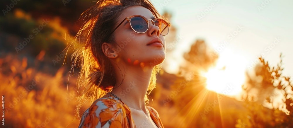 Summer outdoor background with a stylish young woman enjoying herself ...