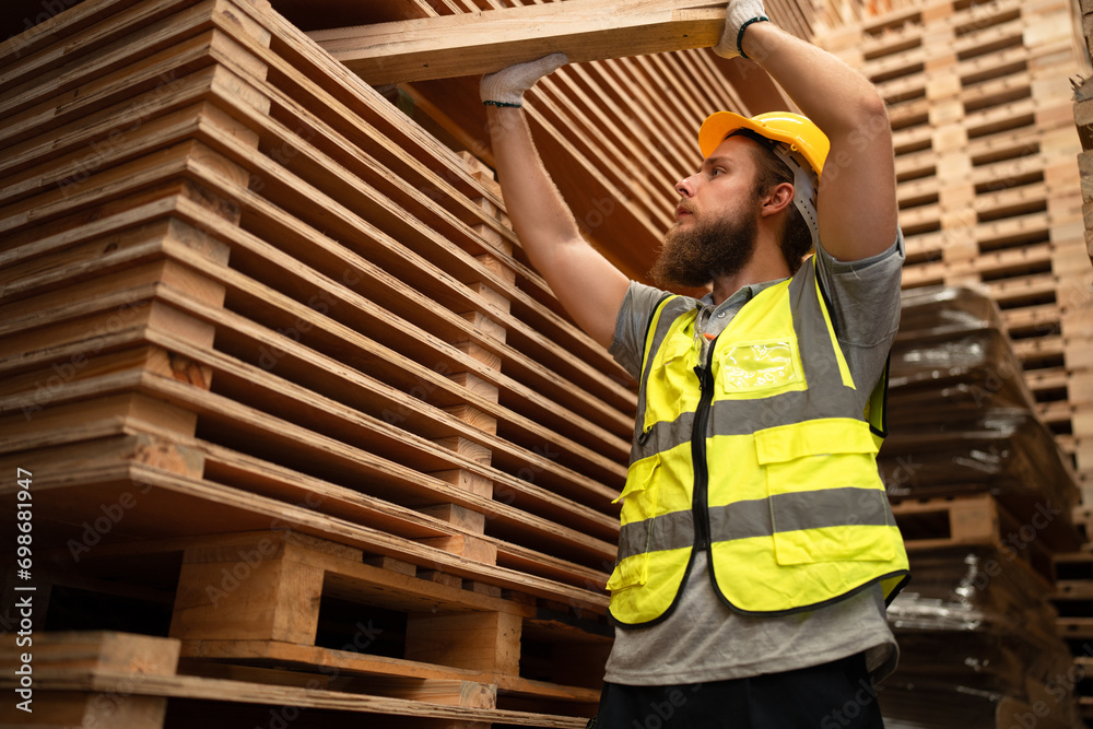 Caucasian business or craft man checking and holding timber with stock ...