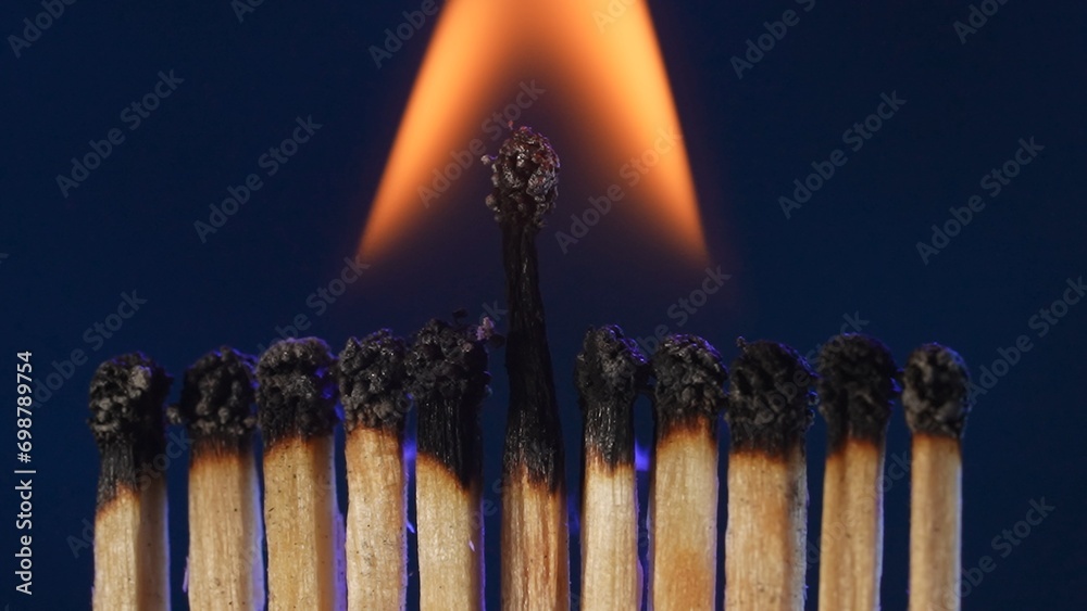 Row of burning matches. Matches burning and illuminating the dark ...