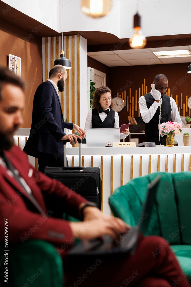 Traveling for work, businessman checking in at hotel reception desk ...