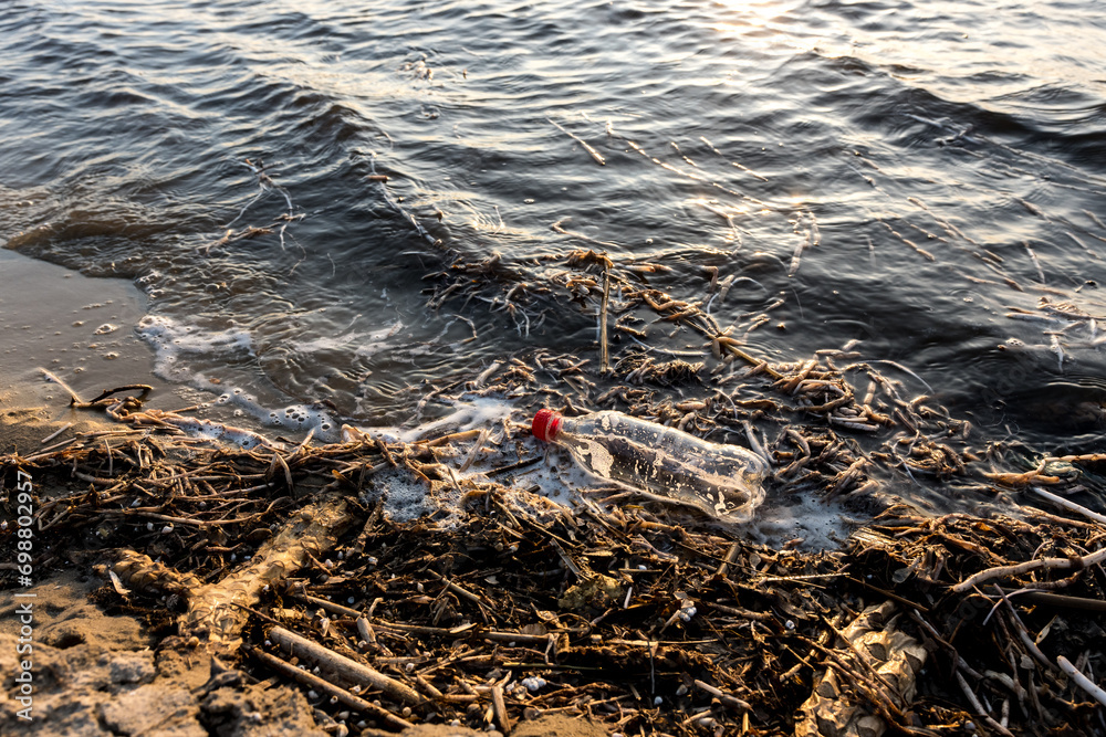 garbage on the river bank. plastic and pollution of nature. Stock Photo ...