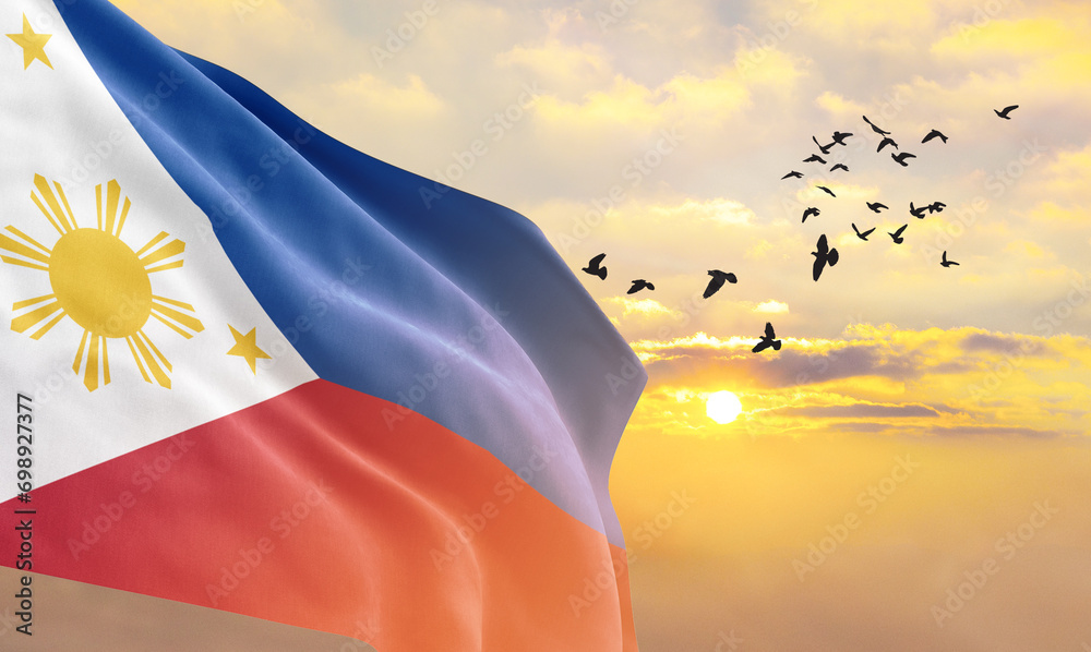 Waving flag of Philippines against the background of a sunset or ...