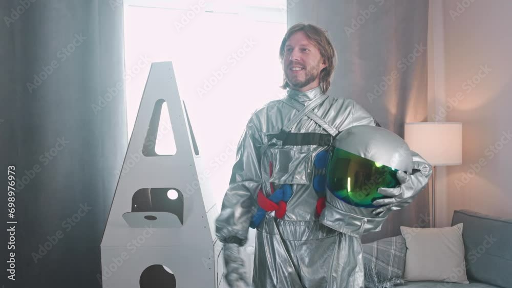 Spaceman, middle-aged man in an astronaut suit stands in living room ...