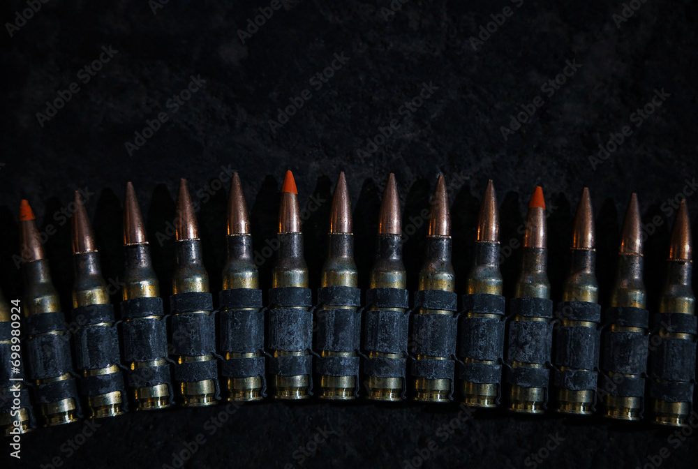 Machine gun bullet belt on the floor. Background on the military theme ...