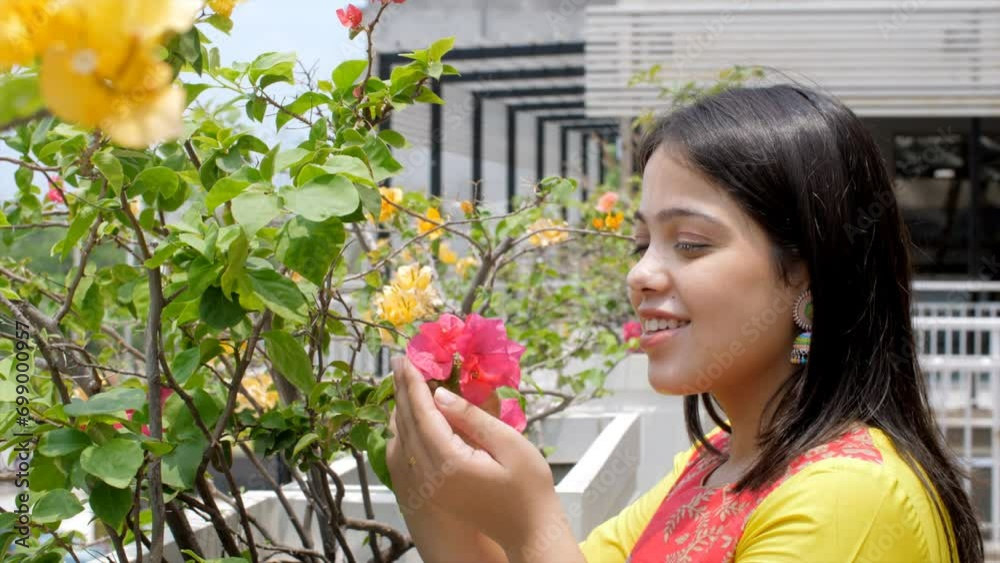 A young Indian woman smells Bougainvillaea flowers - beautiful smile ...