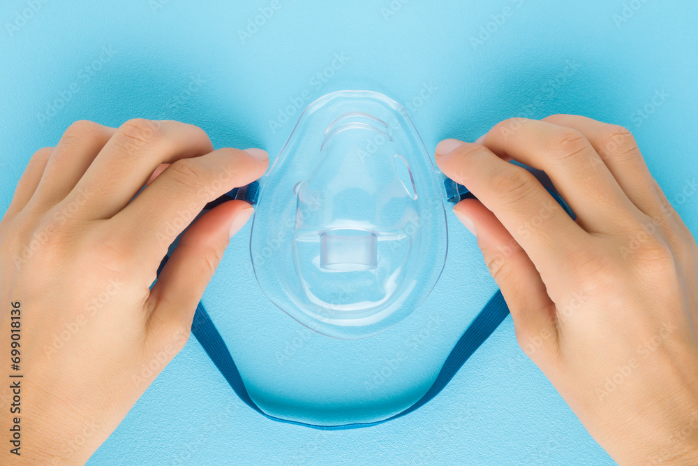 Young adult woman hands holding transparent rubber mask for breathing ...