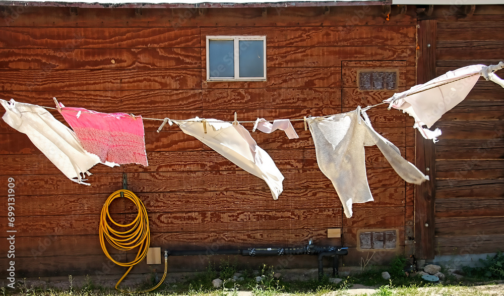 Sheets and clothing dry on an outdoor clothesline on a windy day Stock ...