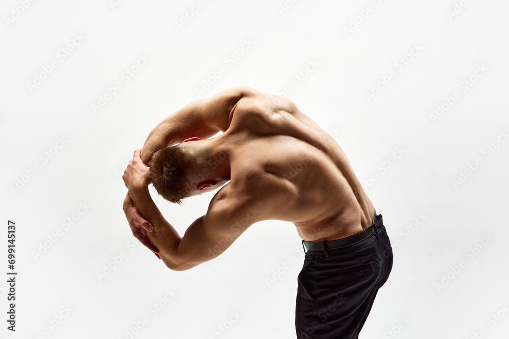 Muscular young man with relief fit shirtless body standing with round ...