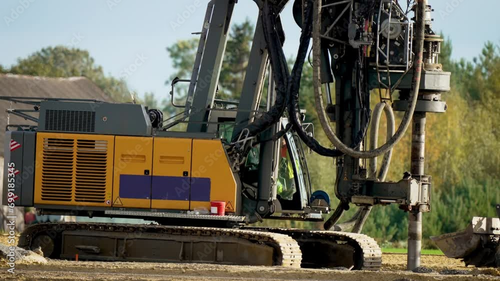 Machine lowers drill down. Drilling water wells. Digs holes in ground ...