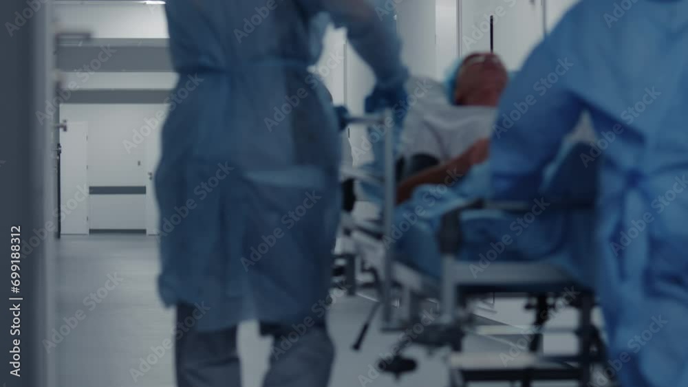 Doctors and nurses run and push gurney with seriously injured patient ...