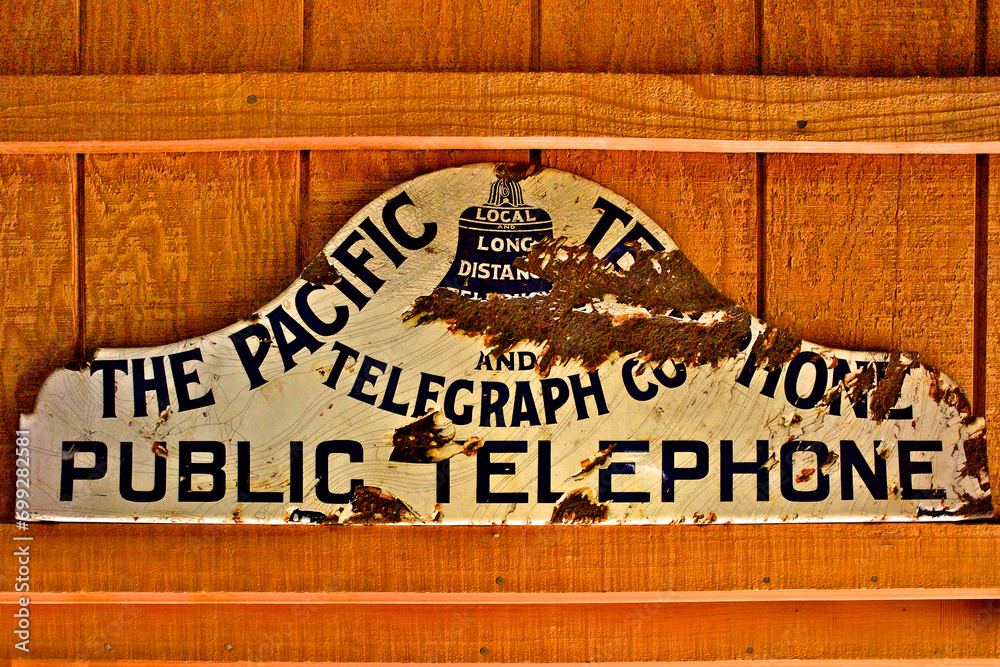 Weather worn vintage “Public Telephone” sign. Old Pacific Telephone and ...