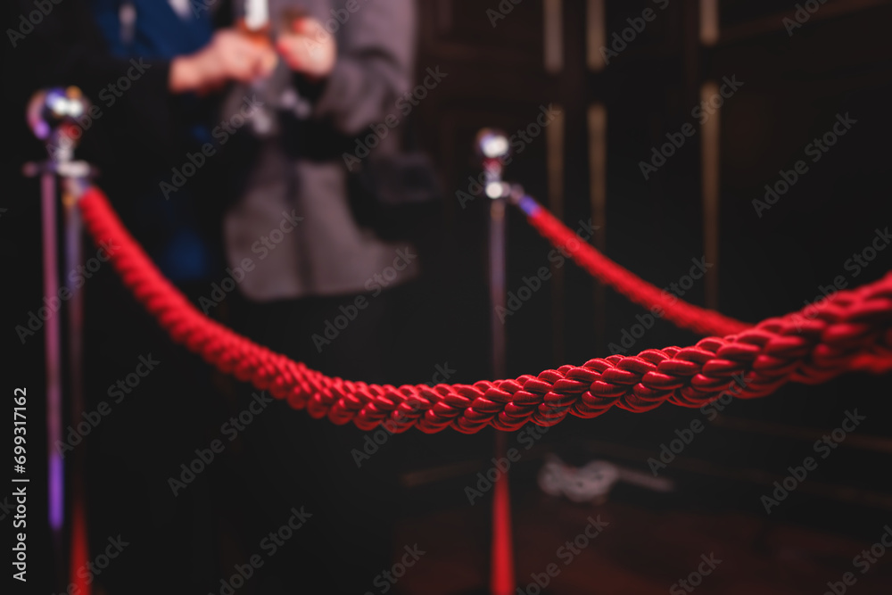 Red carpet with ropes and golden barriers on a luxury party entrance ...