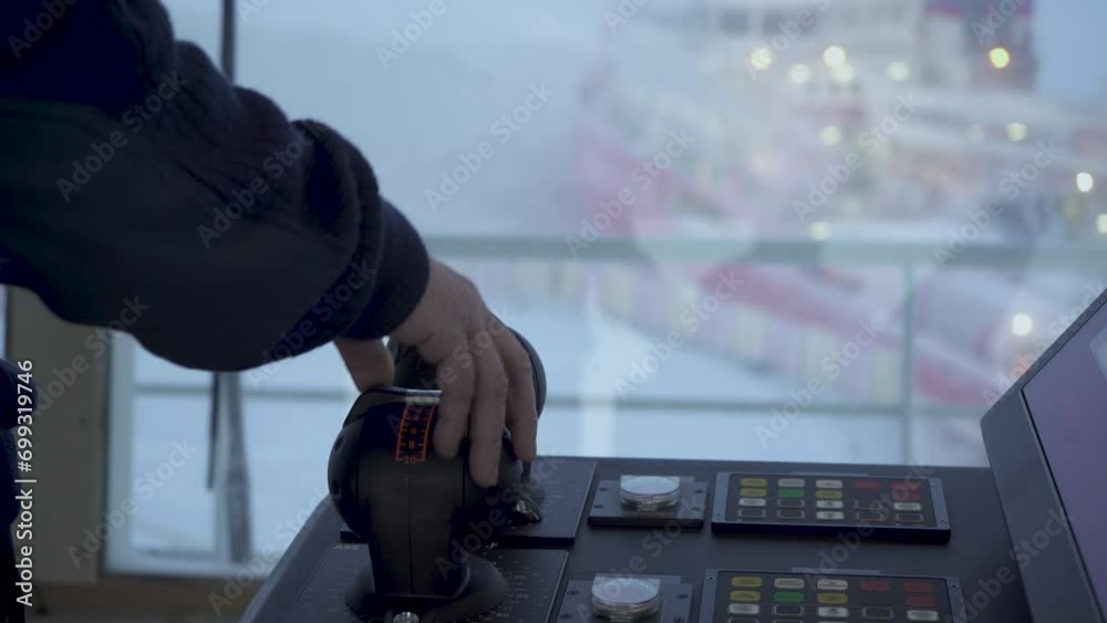 Ship's navigation bridge. Hand is turning azimuth controller on control ...