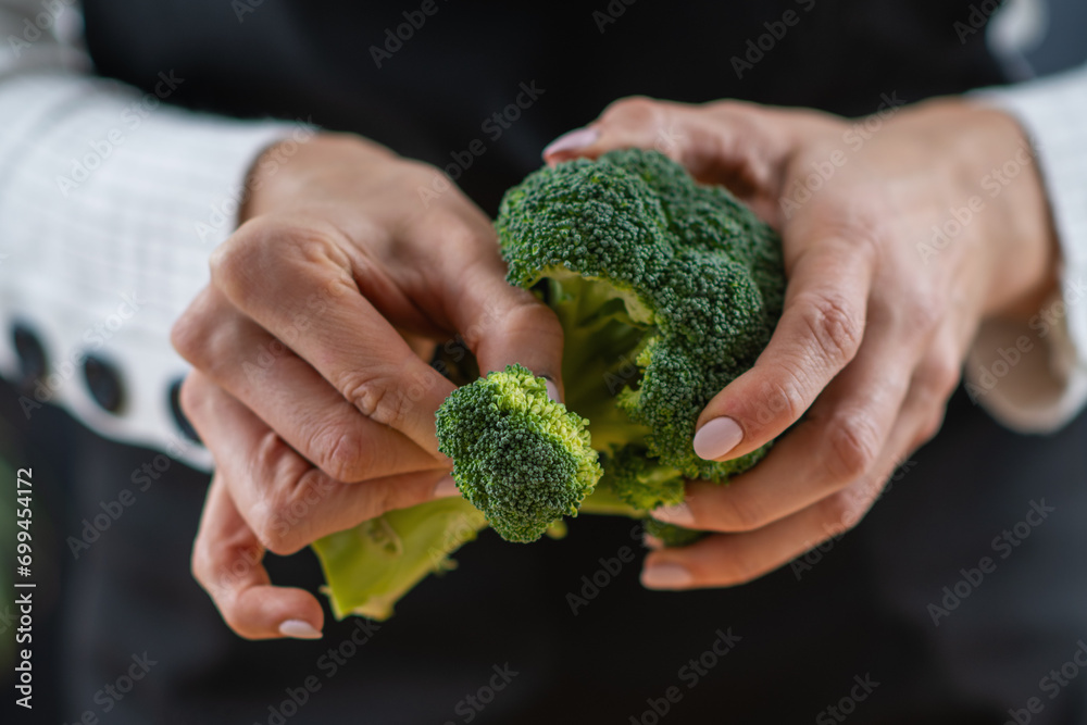 Cutting fresh organic broccoli, a superfood rich in vitamin K, vitamin ...