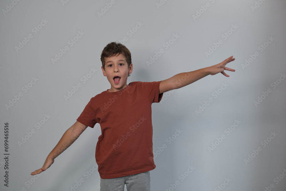 The child's slanted stance and smile radiate playful energy. It ...